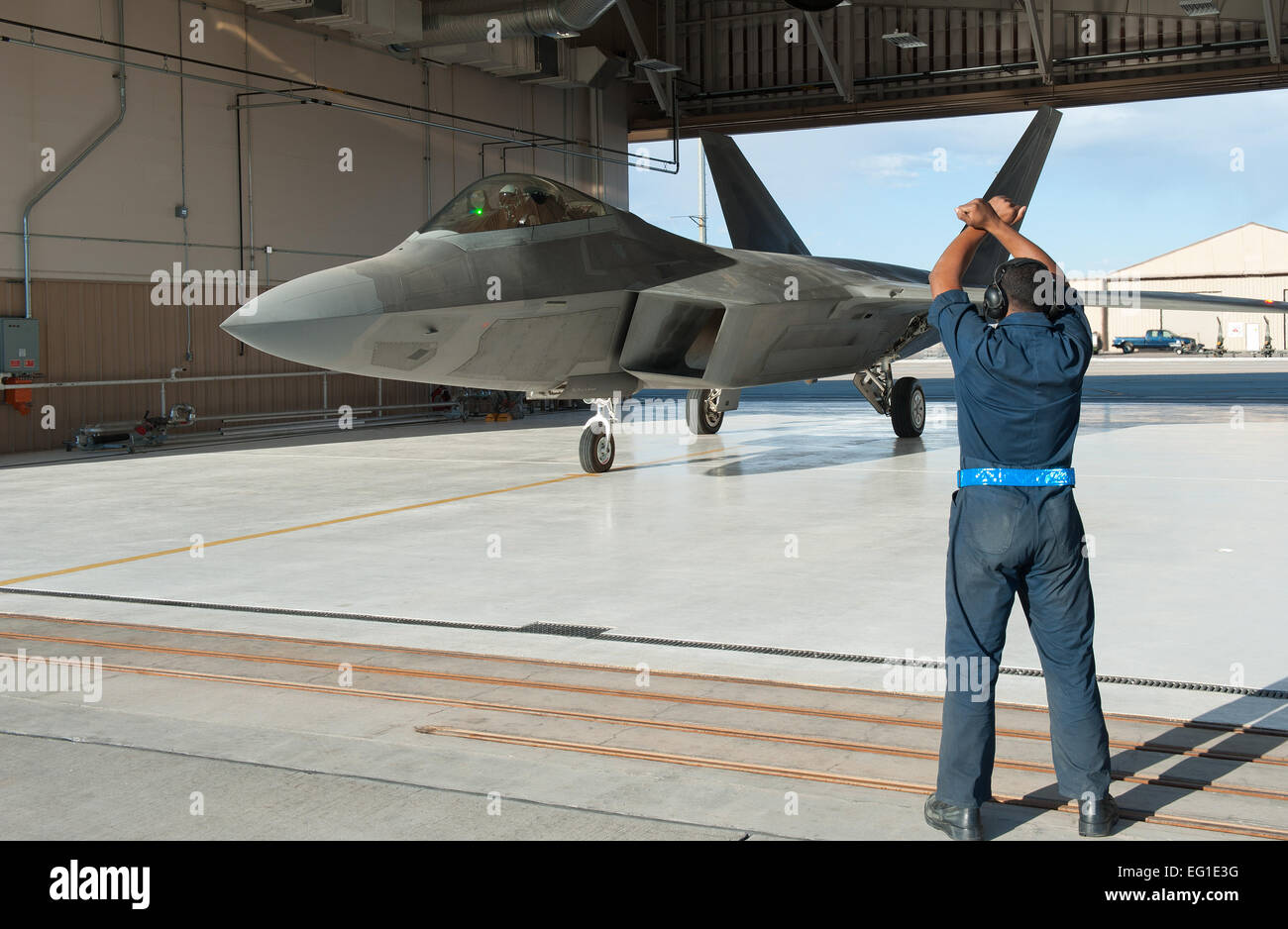 A U.S. Air Force F-22 Raptor fighter aircraft crew chief begins the ...