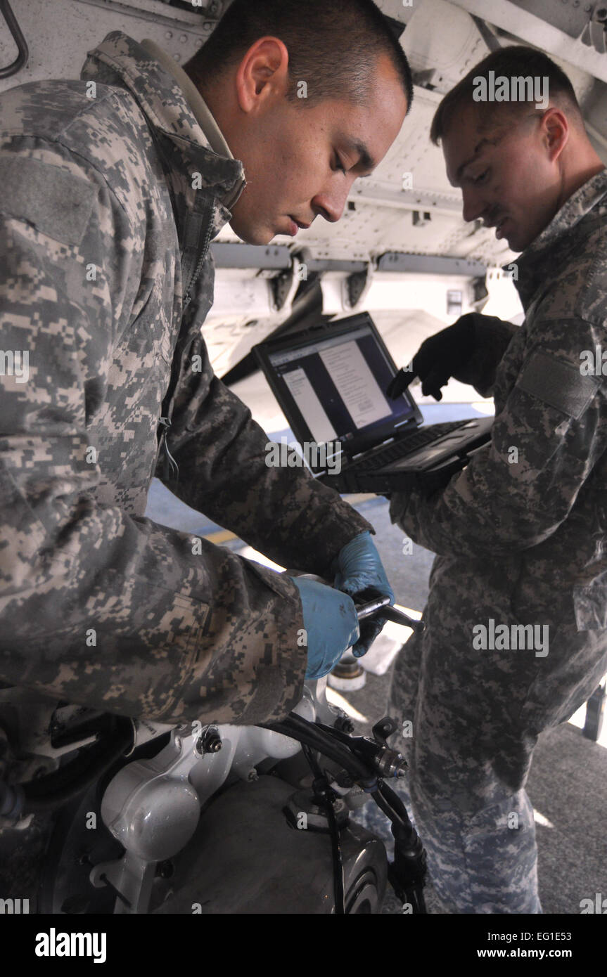 U.S. Air Force Airman 1st Class Tommy Rasmus, right, uses a digital ...