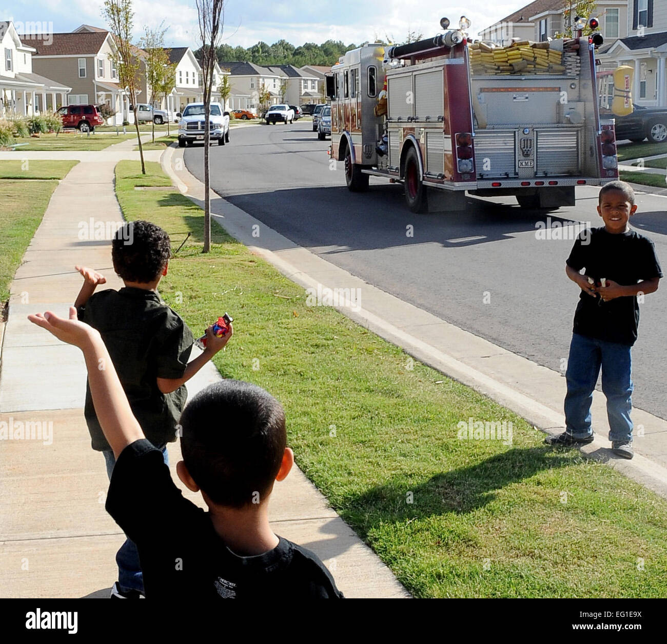 Children wave to a passing fire truck on Barksdale Air Force Base, La ...