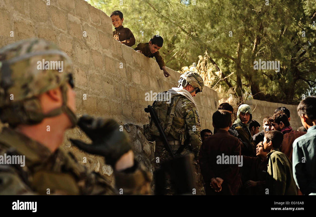 A young boy leans over a wall trying to get the attention of U.S. Air ...