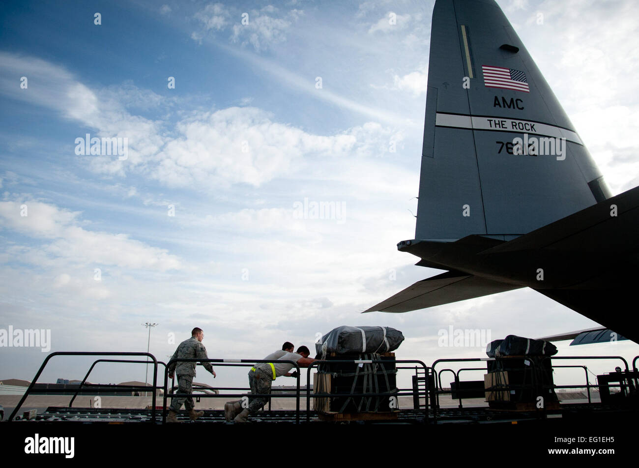 U.S. Air Force Airmen load pallets of cargo into an Air Force C-130J ...