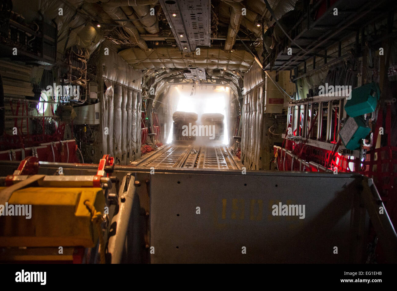 Pallets of cargo exit out the back of an Air Force C-130J Hercules ...