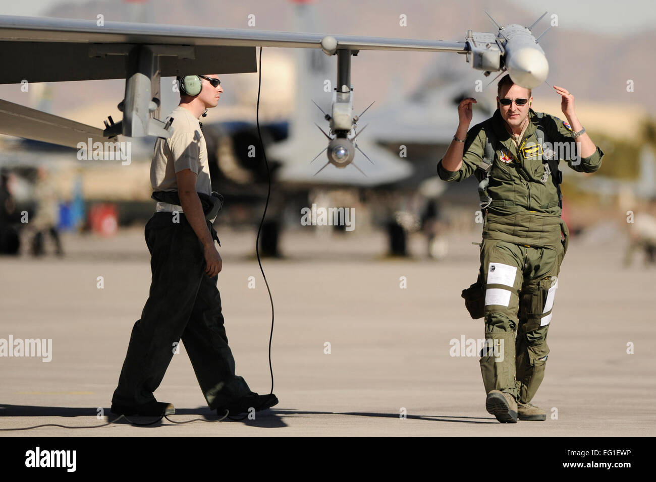 U.S. Air Force Capt. John DiFebo conducts a pre-flight inspection on an ...