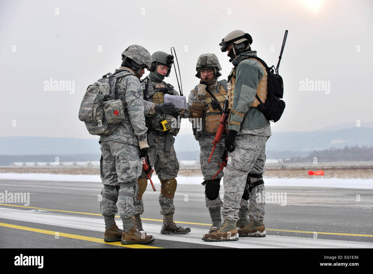 Members of the 435th Contingency Response Group huddle together to ...