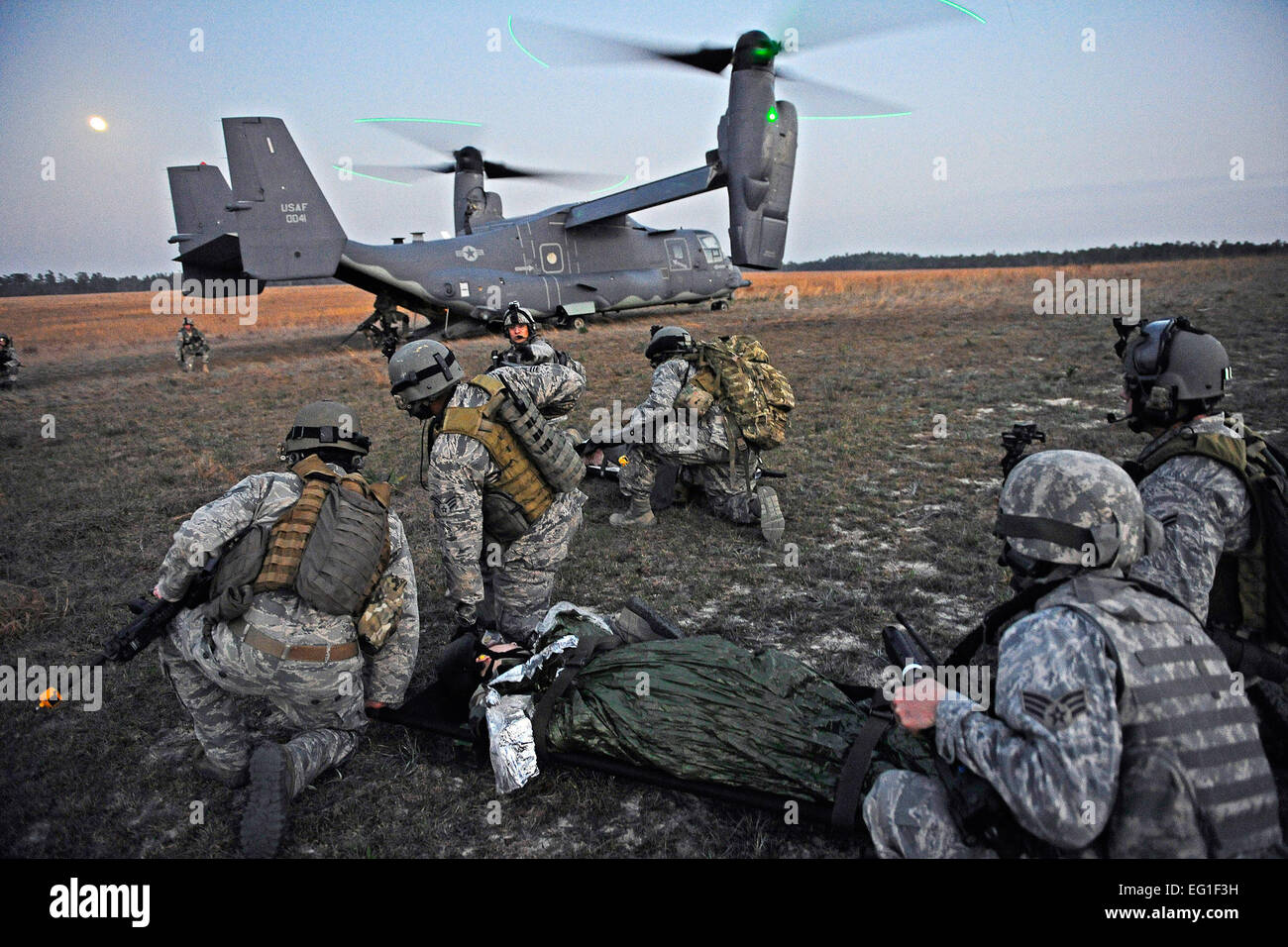 U.S. Air Force Airmen wait to load a simulated aircraft crash victim ...