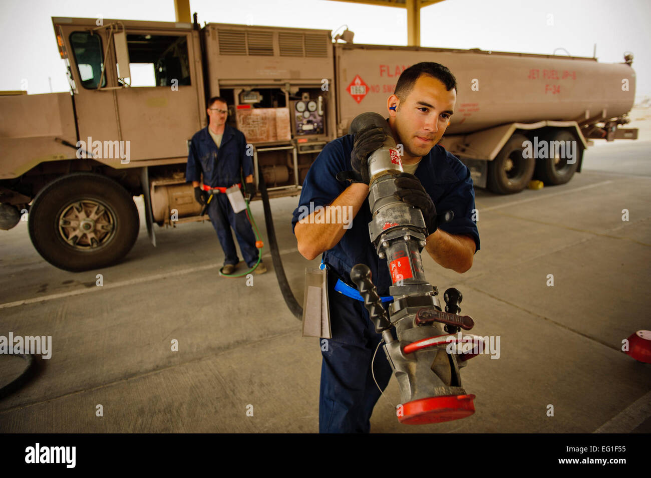 U.S. Air Force Senior Airman Cameron Farrell pulls a hose from a fuel ...