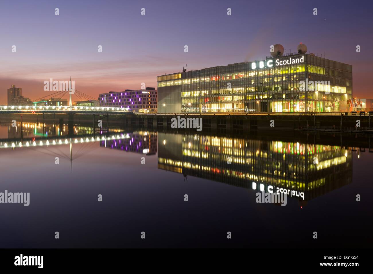 Still refections of the BBC studio's into a clear river Clyde in ...