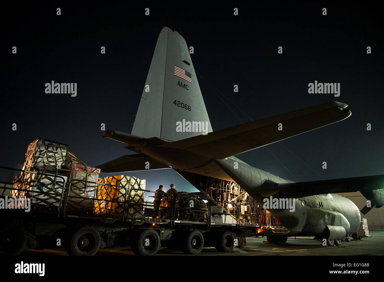 Airmen with the 774th Expeditionary Airlift Squadron load pallets on a ...