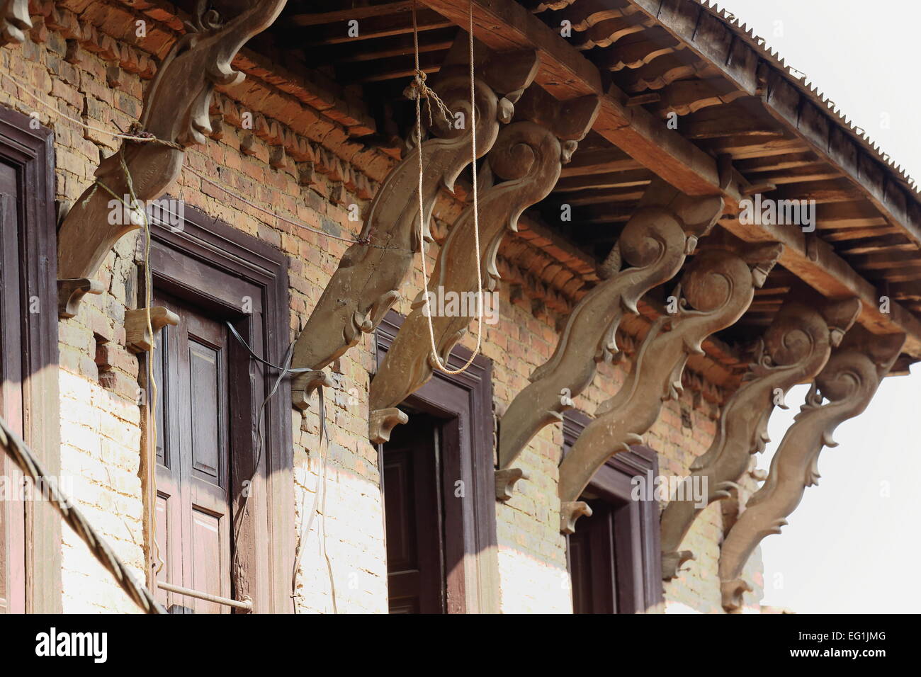 Carved wooden roof struts in the traditional newar style on the red ...