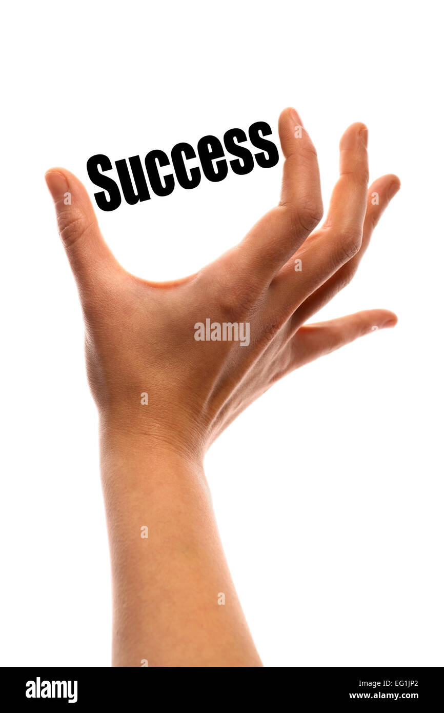 Vertical shot of a hand holding the word "Success" between two fingers ...