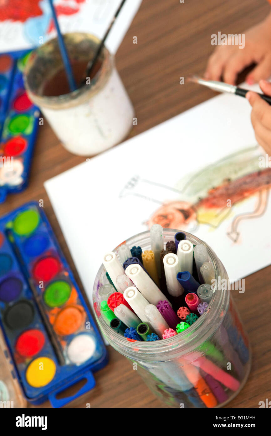 Child coloring a drawing in a workshop Stock Photo - Alamy