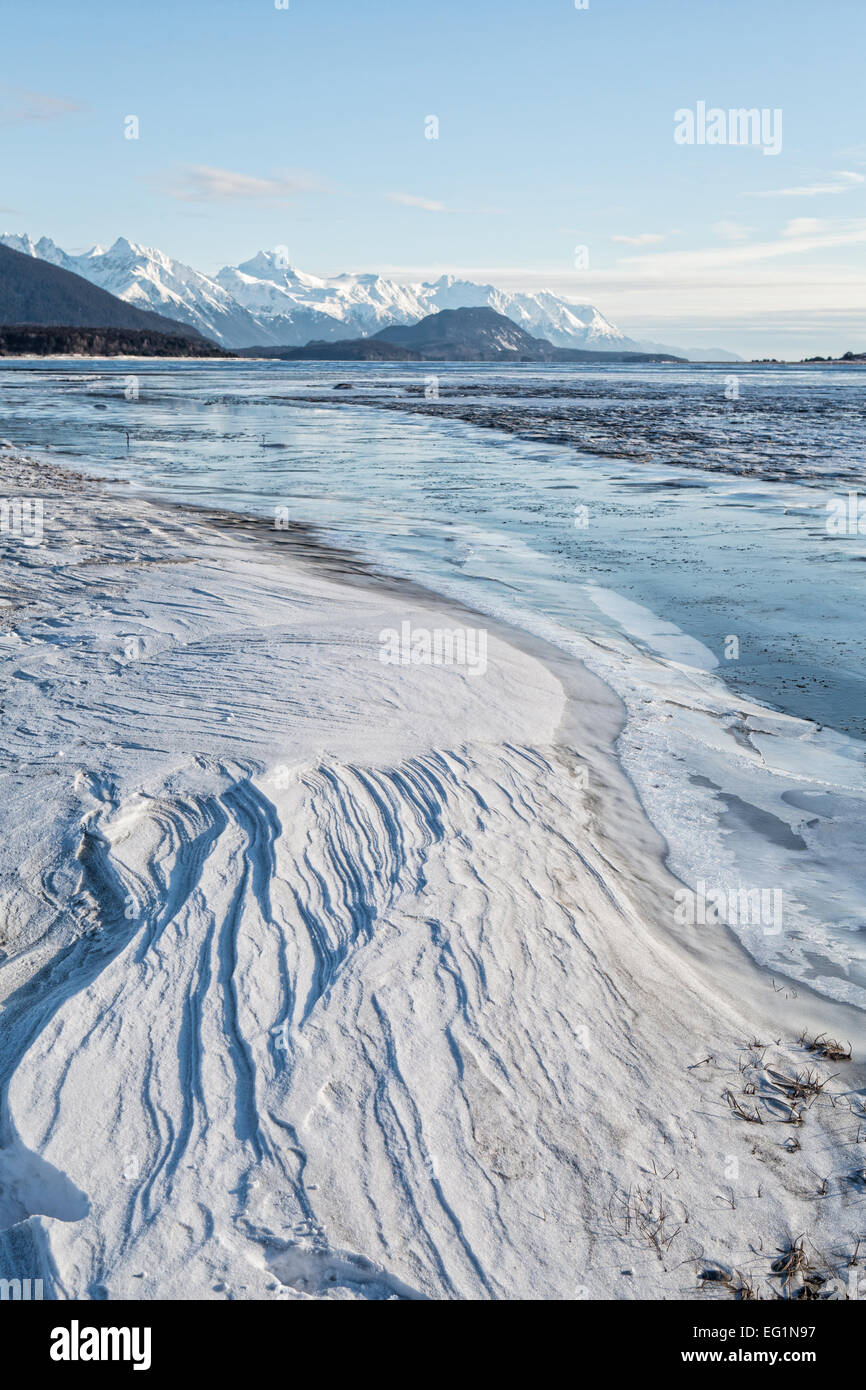 Patterns in wind blown snow beside a frozen Alaskan river Stock Photo ...
