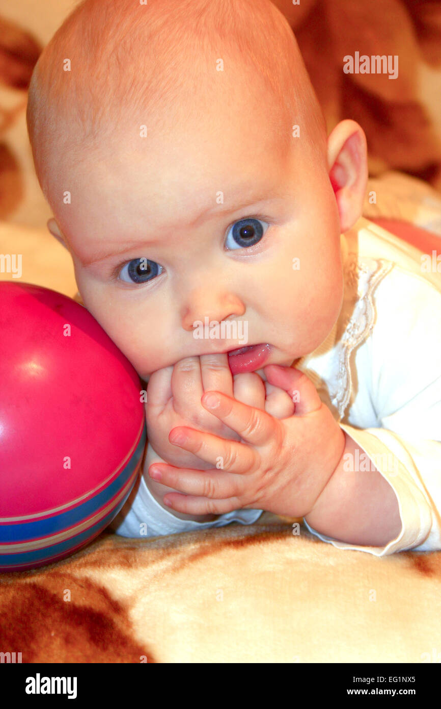 beautiful little baby playing with red ball Stock Photo - Alamy