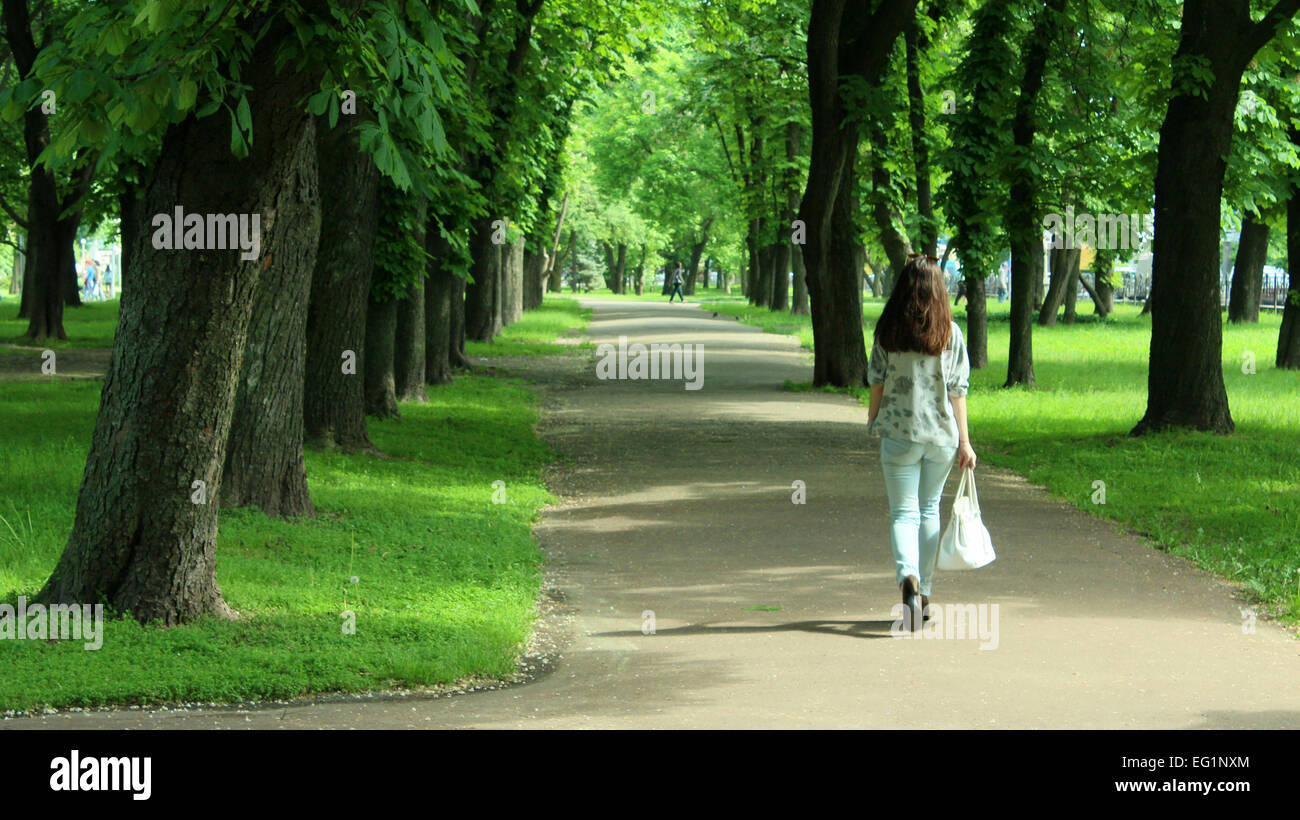 young women walking on the beautiful park with many green trees Stock ...