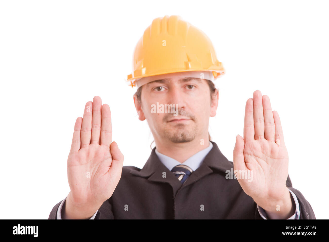 Engineer with yellow hat making stop sign - focus on hands Stock Photo ...