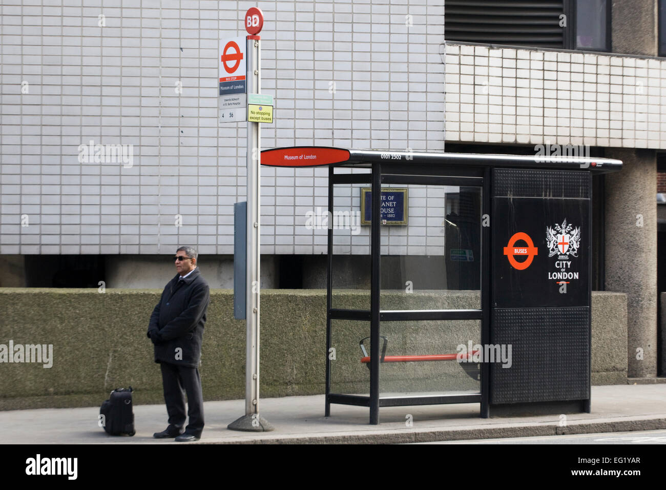 Man waiting bus stop sign hi-res stock photography and images - Alamy