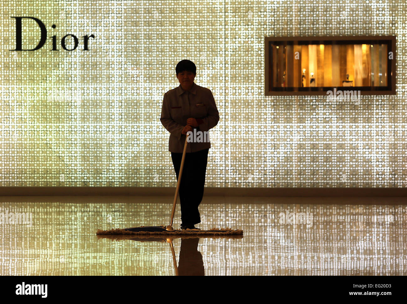 Shanghai, CHINA. 28th Jan, 2015. A Chinese custodian sweeps the floor ...