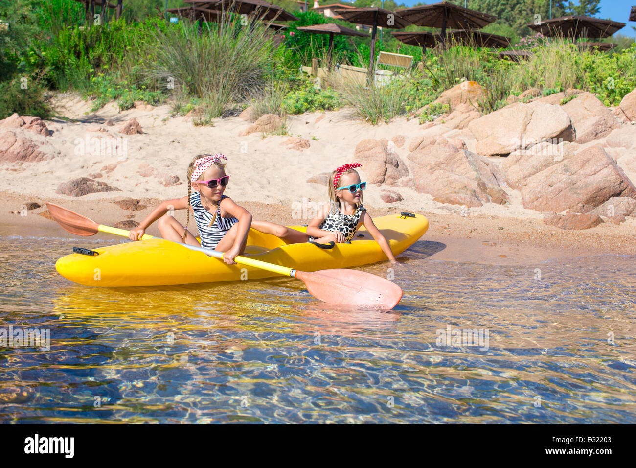 Little adorable girls enjoying kayaking on yellow kayak Stock Photo - Alamy