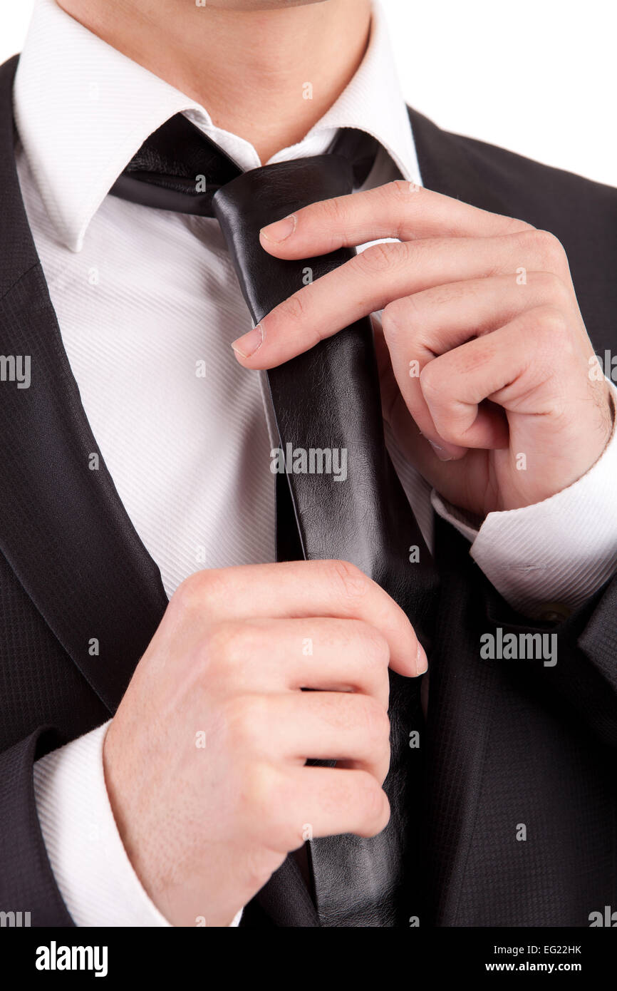 Business man fixing his tie, isolated over white Stock Photo - Alamy
