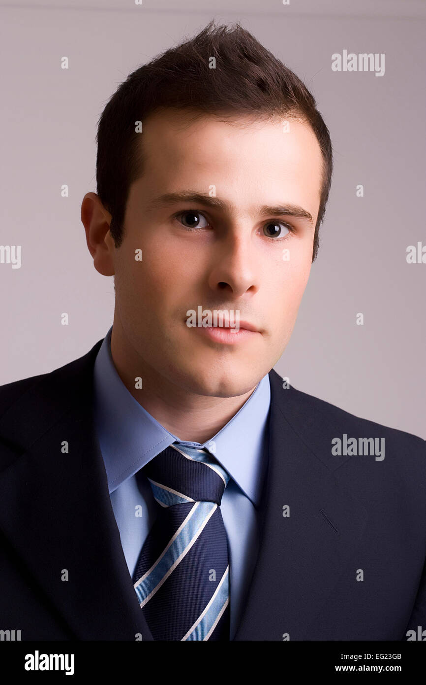Portrait of young businessman - isolated in grey background Stock Photo ... Portrait of young businessman - isolated in grey background Stock Photo ...