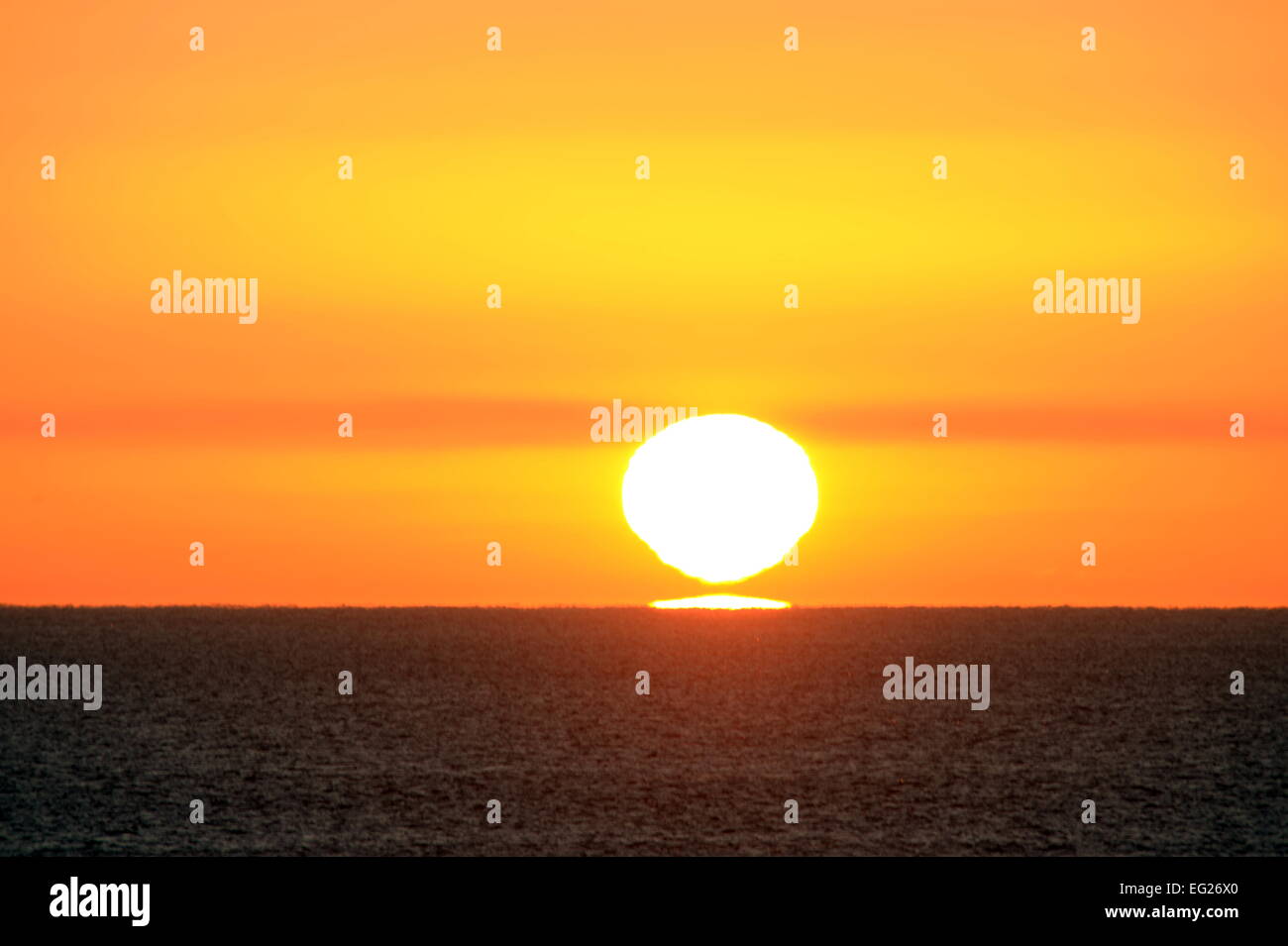 Golden sun rise sequence.As if glued to the water the mornings as an ...