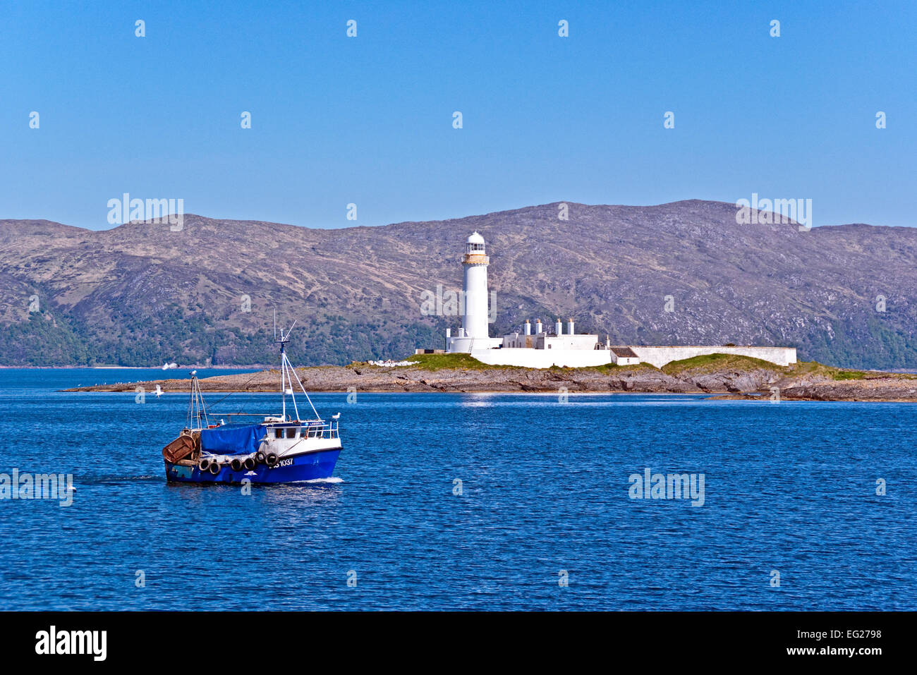 Fishing boat heading for Mallaig in Highland Scotland passes the ...