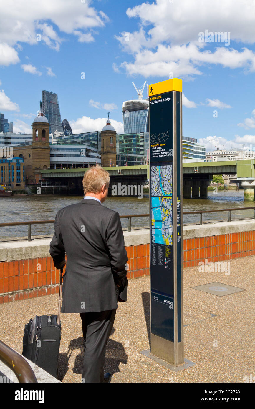 Businessman looks for directions in central London Stock Photo - Alamy