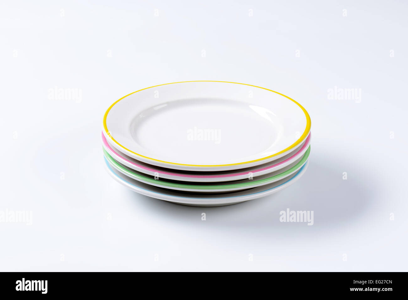 Set of rimmed plates with pastel colored edges Stock Photo - Alamy