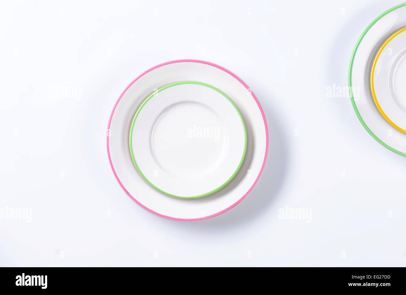 Set of rimmed plates with pastel colored edges Stock Photo - Alamy