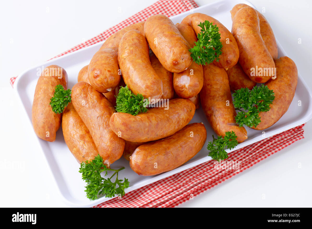 Pile of short kielbasa sausages on plate Stock Photo - Alamy
