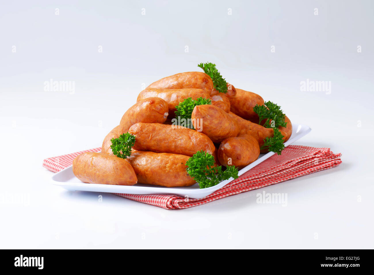 Pile of short kielbasa sausages on plate Stock Photo - Alamy