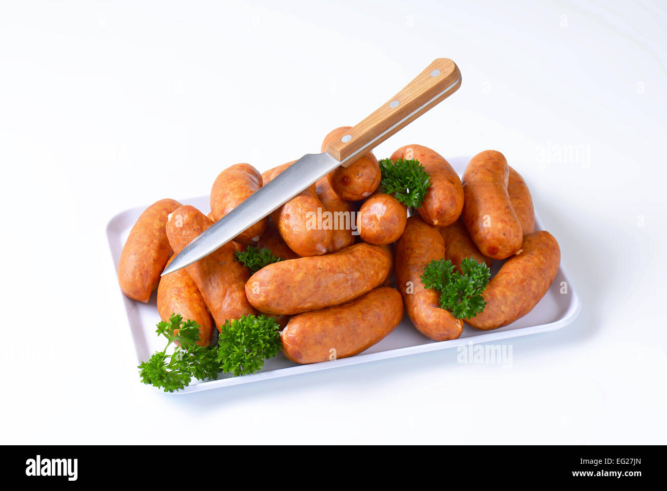 Pile of short kielbasa sausages on plate Stock Photo - Alamy