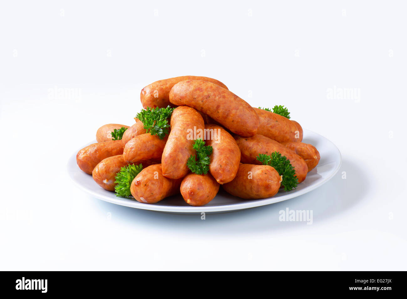 Pile of short kielbasa sausages on plate Stock Photo - Alamy