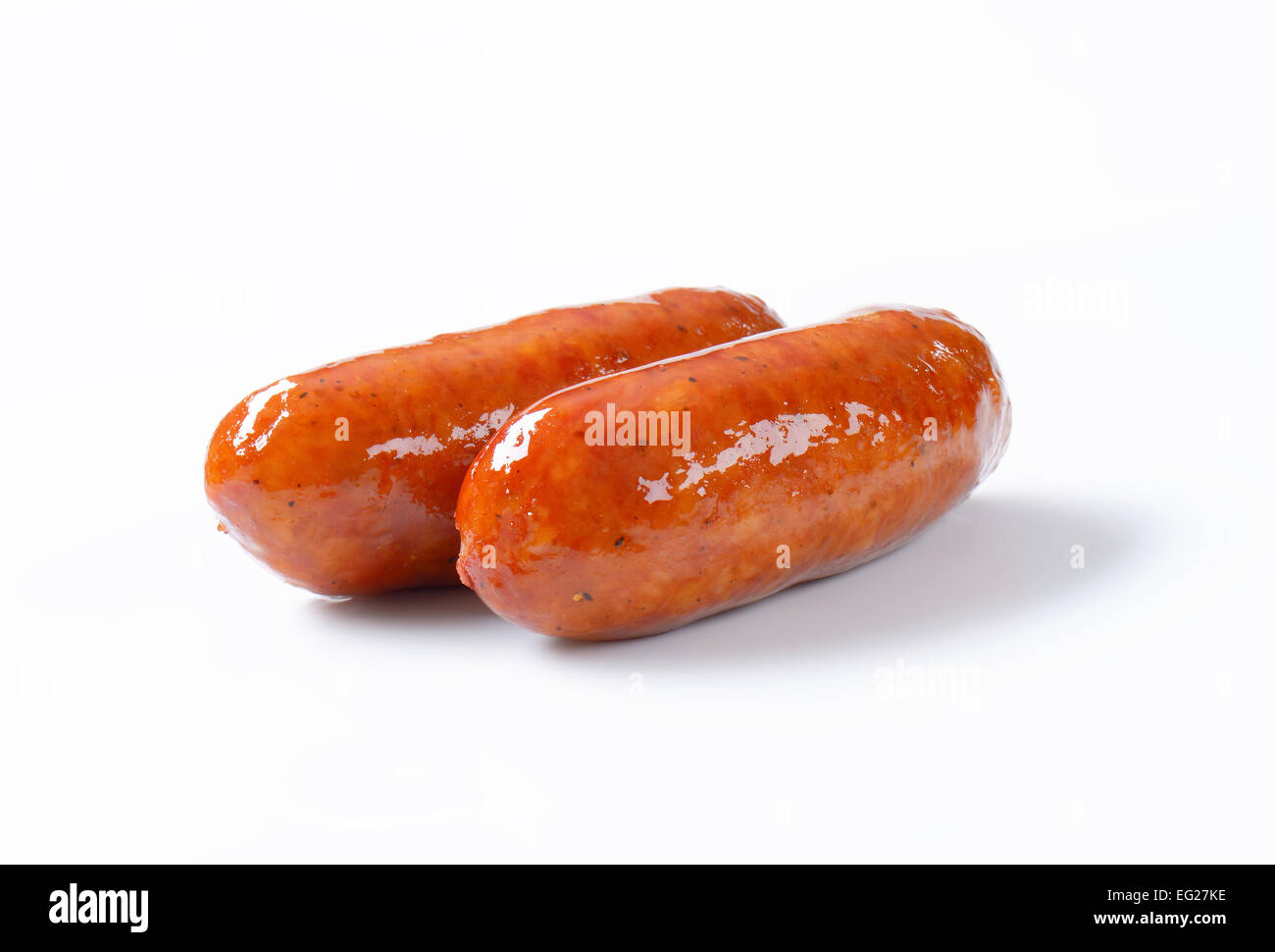 Two grilled sausages on white background Stock Photo - Alamy