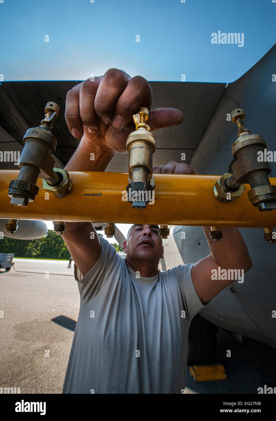 Master Sgt. Steven Feliz opens the nozzles of a Modular Aerial Spray ...