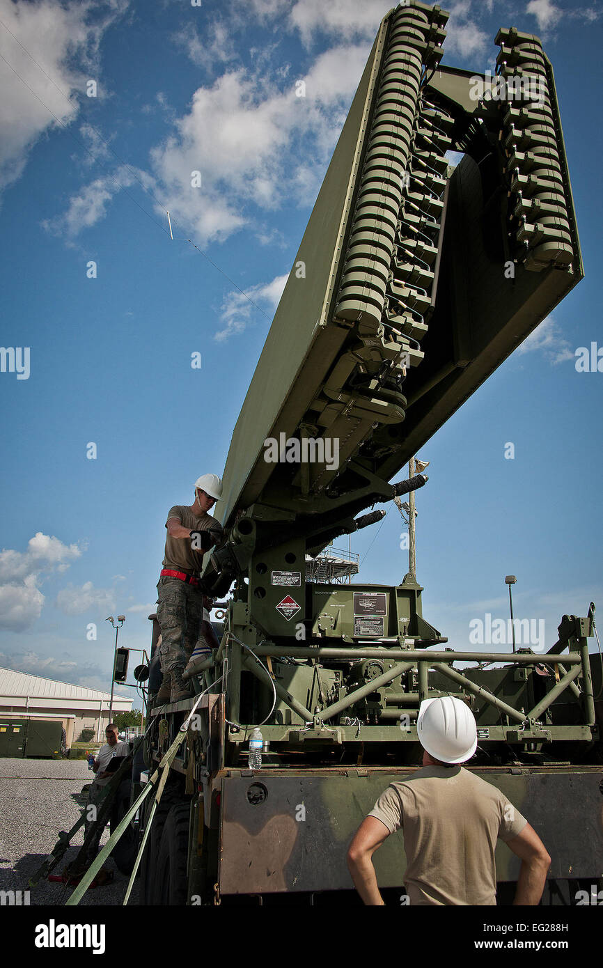 Airman 1st Class Daniel Hilliard hand cranks the deployment of a TPS-75 ...