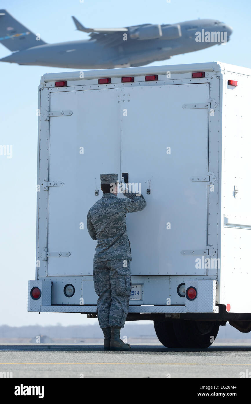 Senior Airman Tyler Wright secures the doors of a transfer vehicle ...