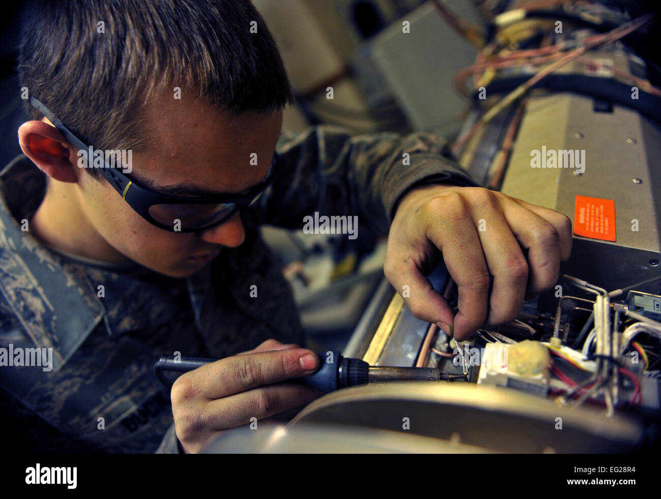 Senior Airman Jonathon Buck checks the functionality of a component on ...