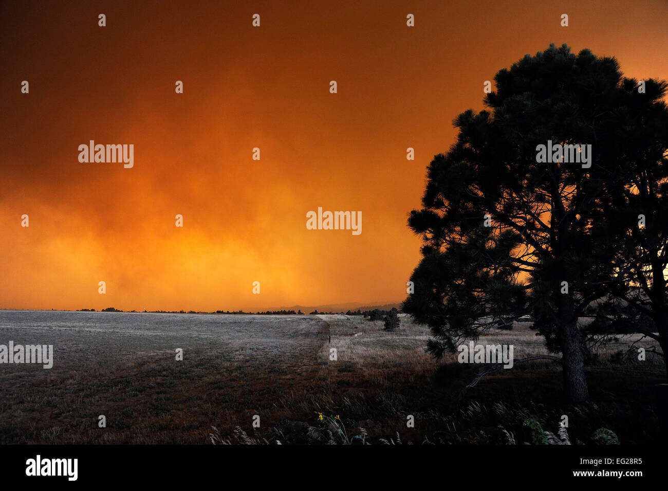 A rapidly spreading smoke cloud surrounds the U.S. Air Force Academy's ...
