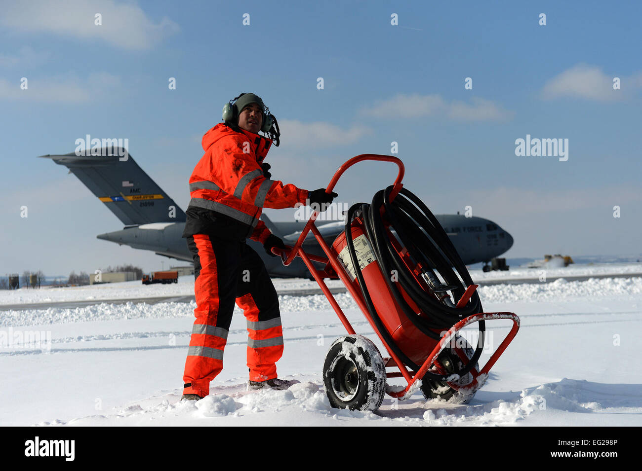 Senior Airman Bryan Rodriguez positions a fire bottle on the flightline ...