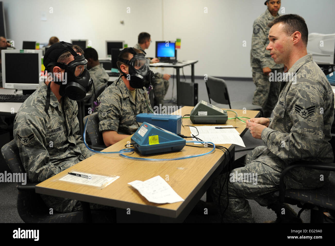 U.S. Air Force Senior Airman Donary Scully, right, instructs Airmen 1st ...