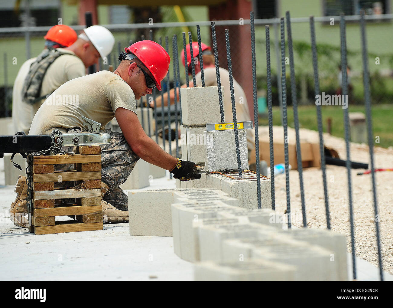 Air Force civil engineers and Army combat heavy engineers lay mortar on ...