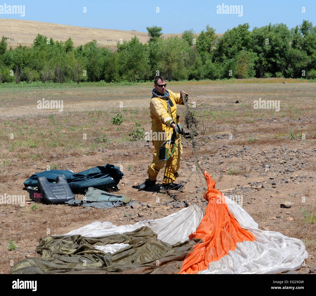 A U-2 pilot gathers his parachute during a combat search and rescue ...