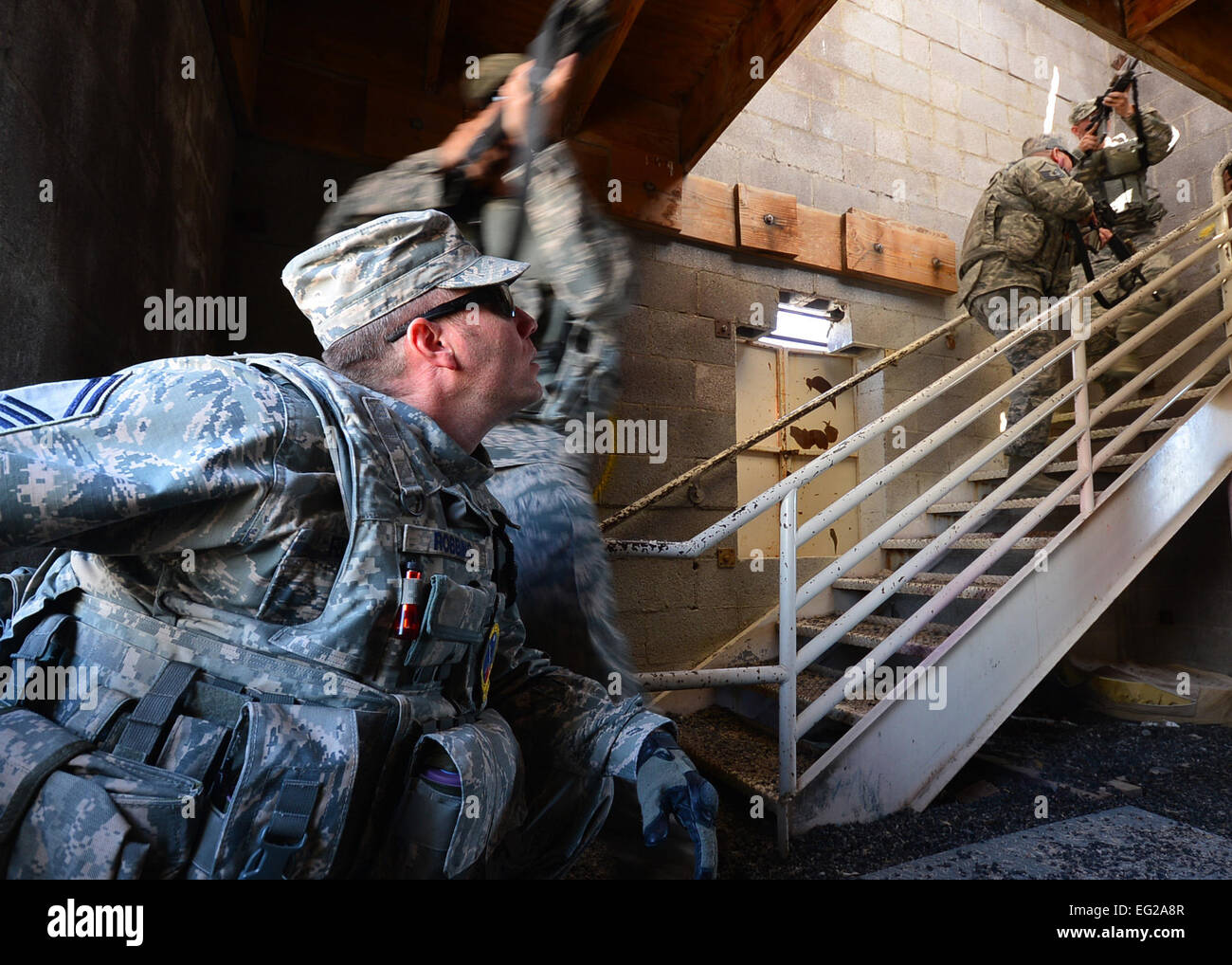 Senior Master Sgt. James Robbins demonstrates proper building clearing ...