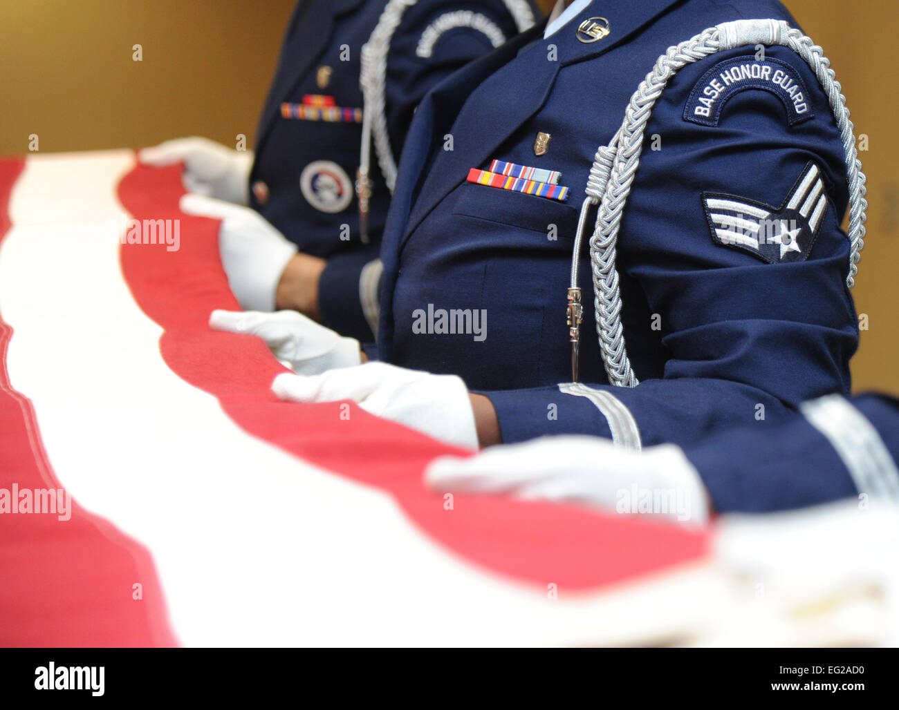 Keesler Honor Guard members conduct a flag-folding ceremony over a ...