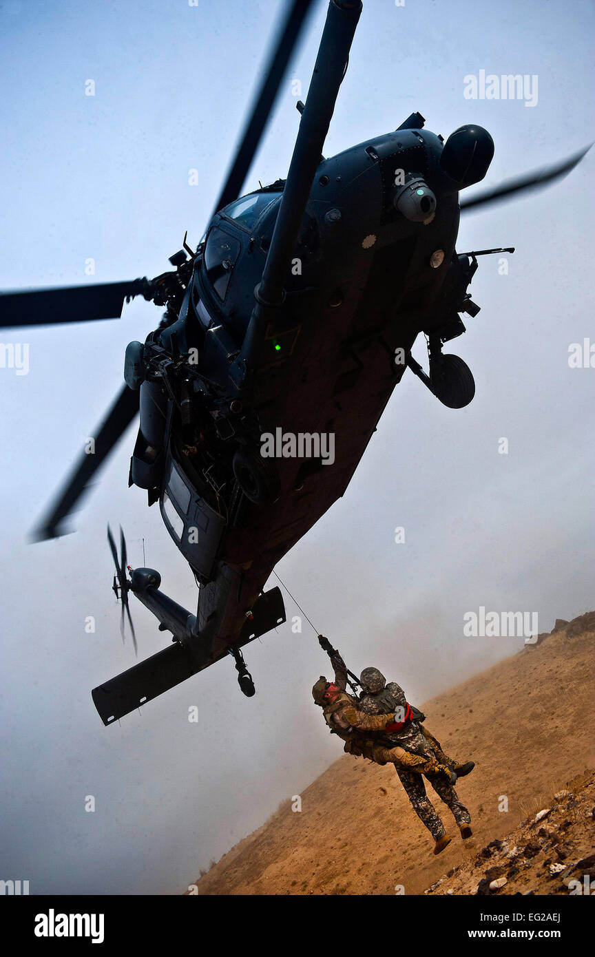 A pararescueman hoists a survivor into an HH-60 Pave Hawk during a ...