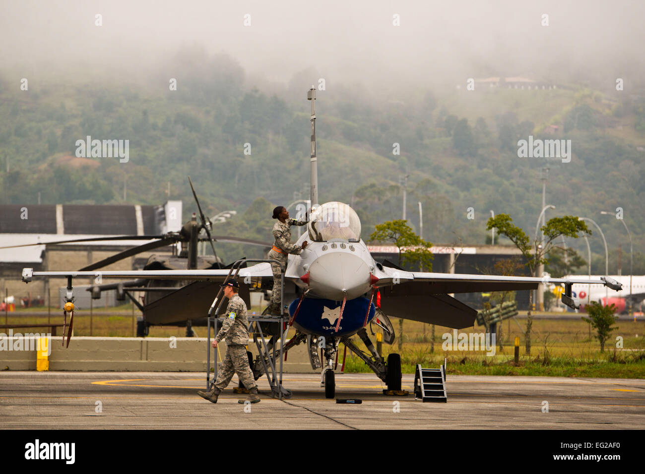 A crew chief cleans the canopy of an F-16 Fighting Falcon Aug. 12, 2014 ...