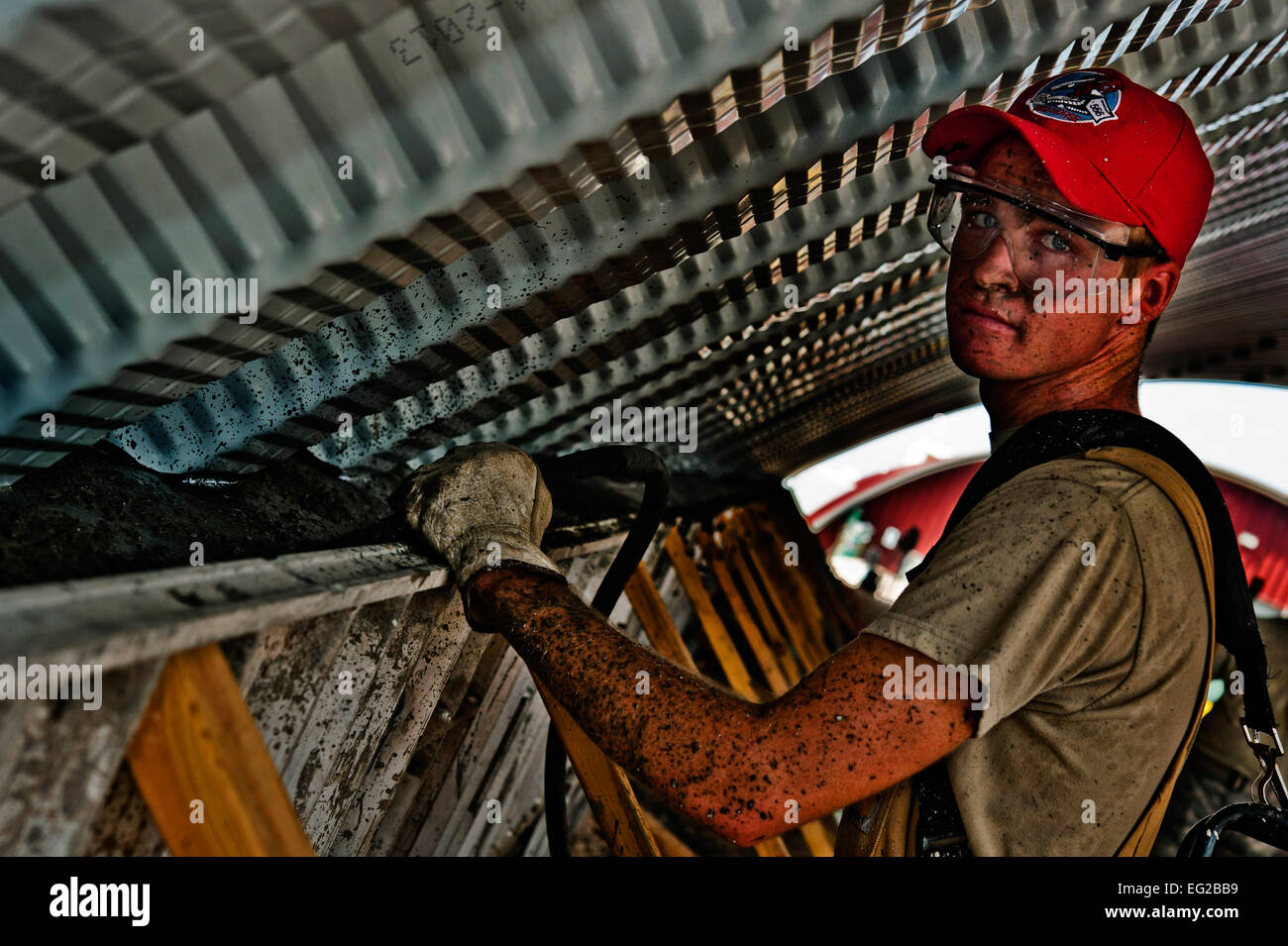 Senior Airman Jonathan Jensen uses a concrete hummer vibrator to ...