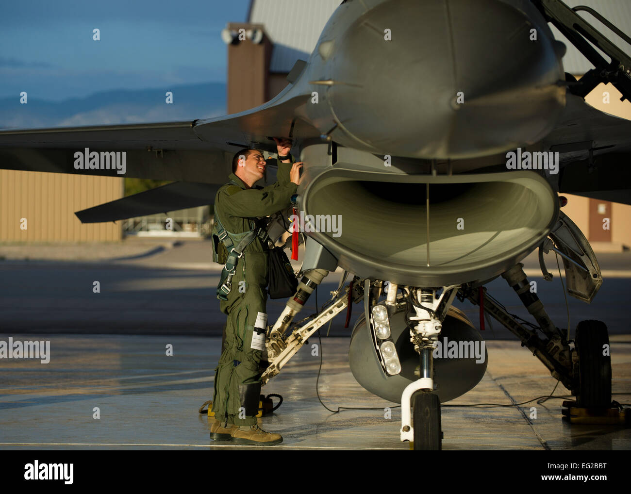 Captain Jake Pippenger, 54th Fighter Group pilot, inspects an F-16 ...