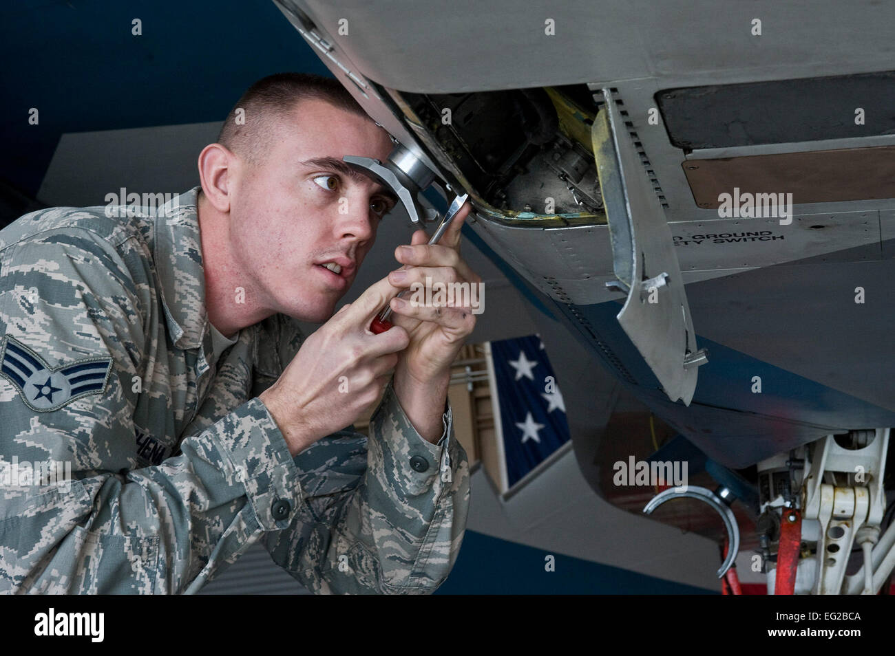 Senior Airman Michael Schena prepares to load an AIM-120C missile on to ...